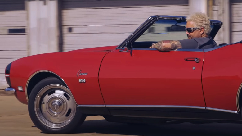 Guy Fieri Doesn't Really Drive The Red Camaro To Every Diners, Drive-Ins, And Dives Stop
