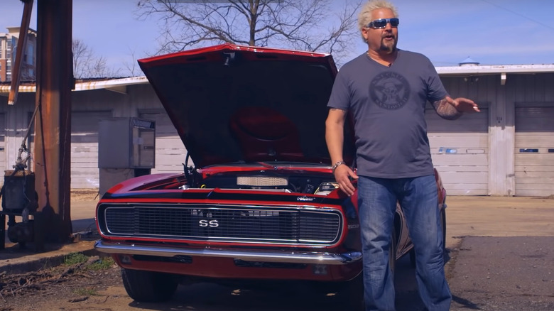 Guy Fieri Doesn't Really Drive The Red Camaro To Every Diners, Drive-Ins, And Dives Stop