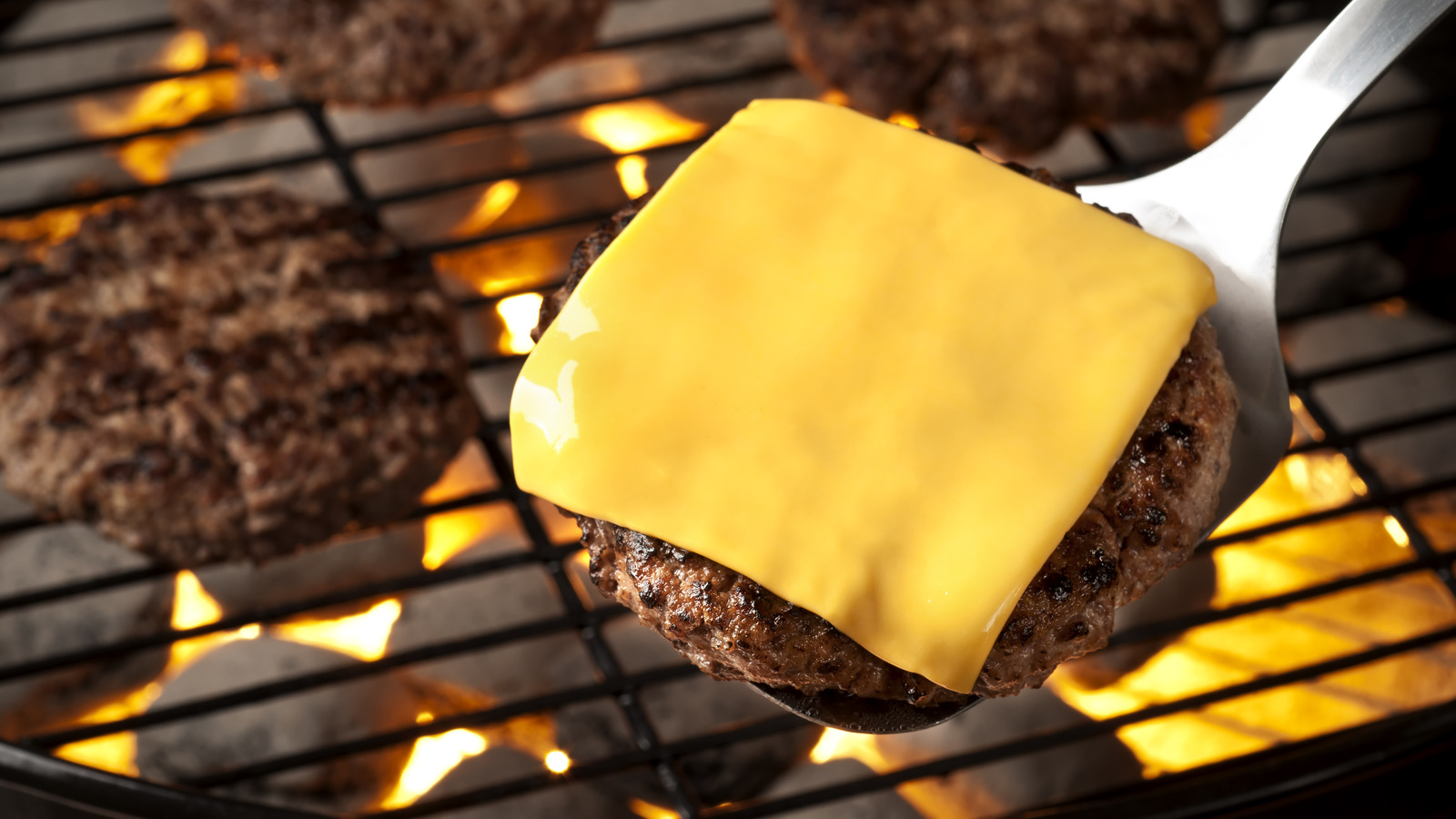 The Hack For Achieving Perfectly Melted Cheese When Grilling Burgers