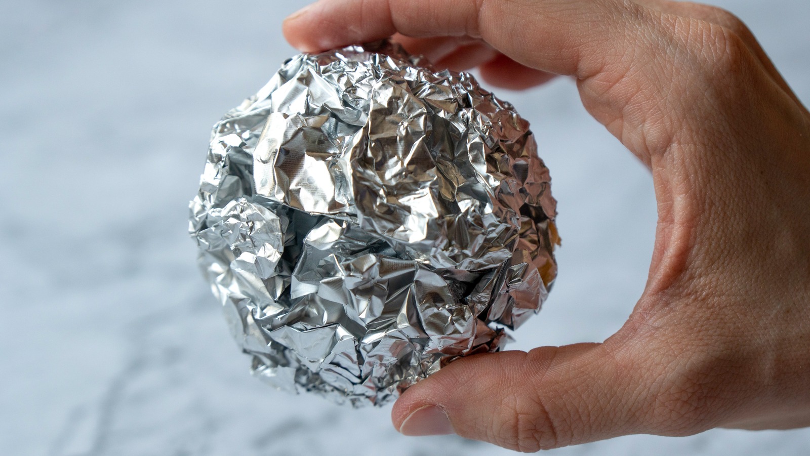 Your Secret For A Sparkling Kitchen Sink Is Aluminum Foil